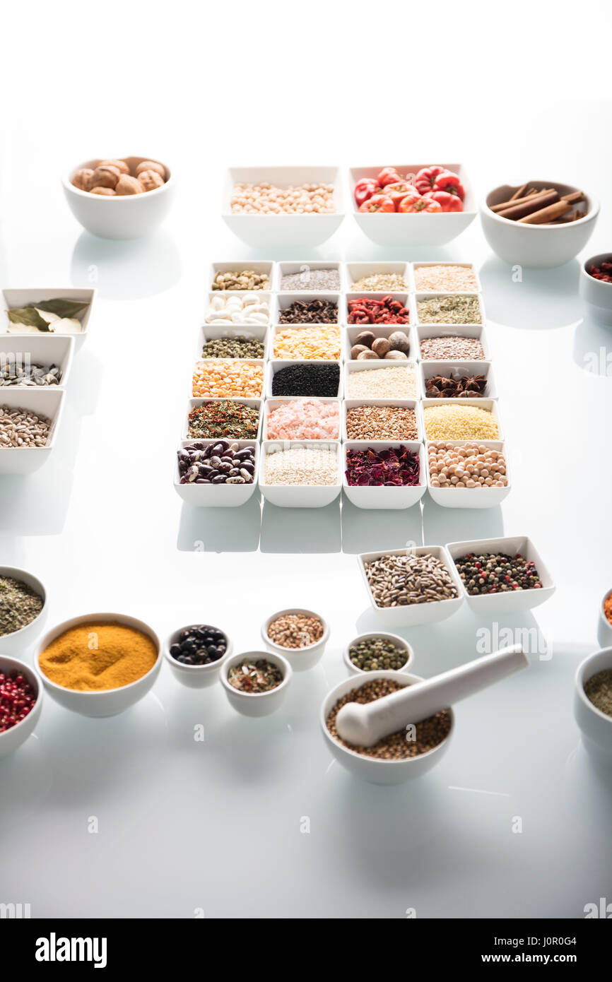 Spices and leguminous vegetables in bowls, isolated on white background ...