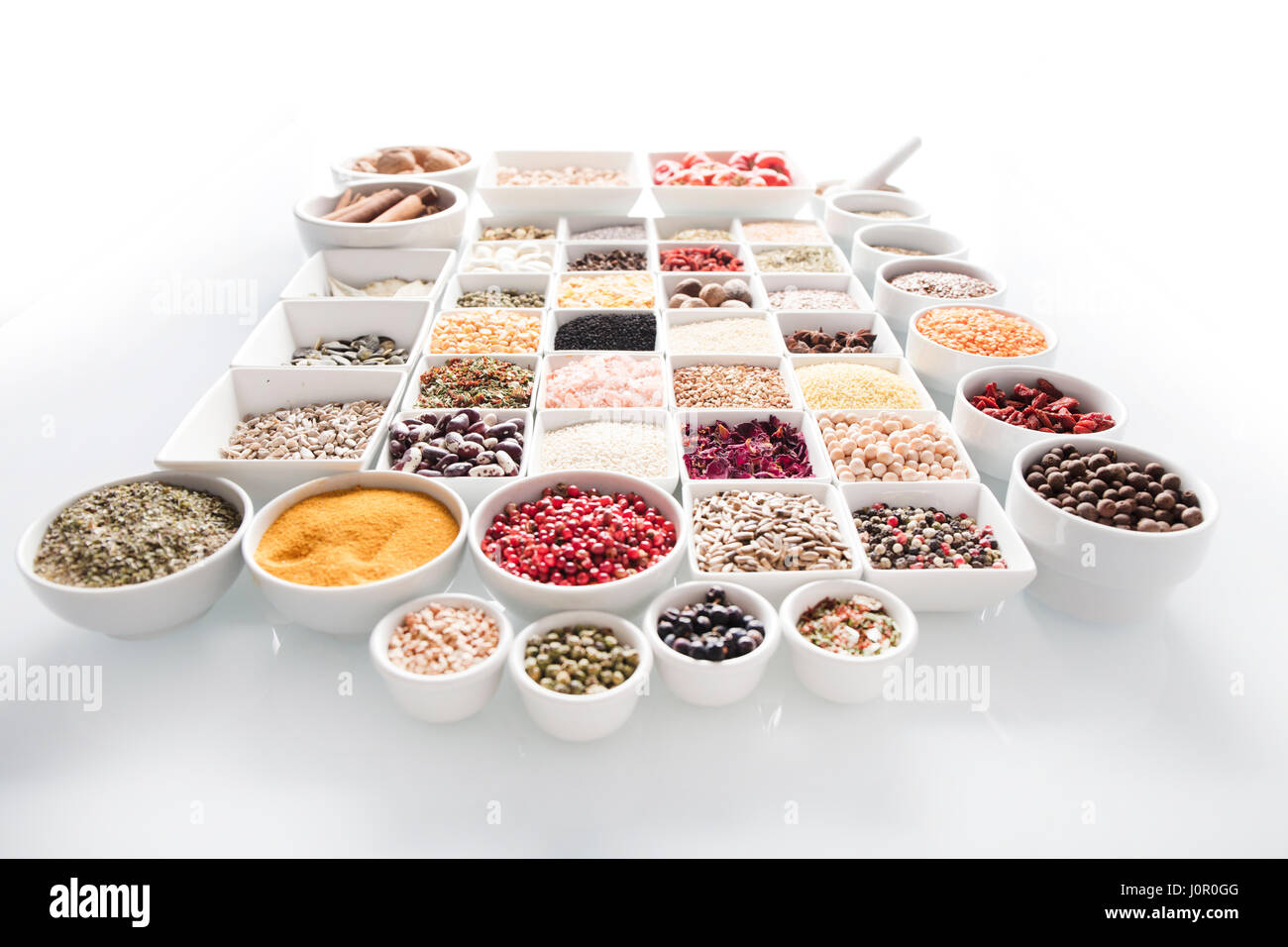 Spices and leguminous vegetables in bowls, isolated on white background ...