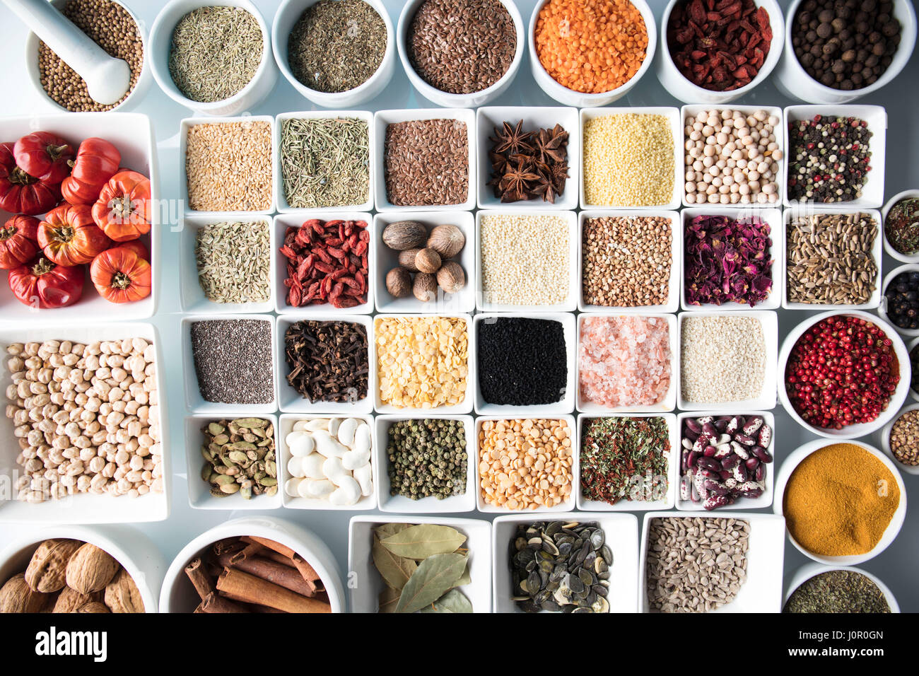 Spices and leguminous vegetables in bowls, isolated on white background ...