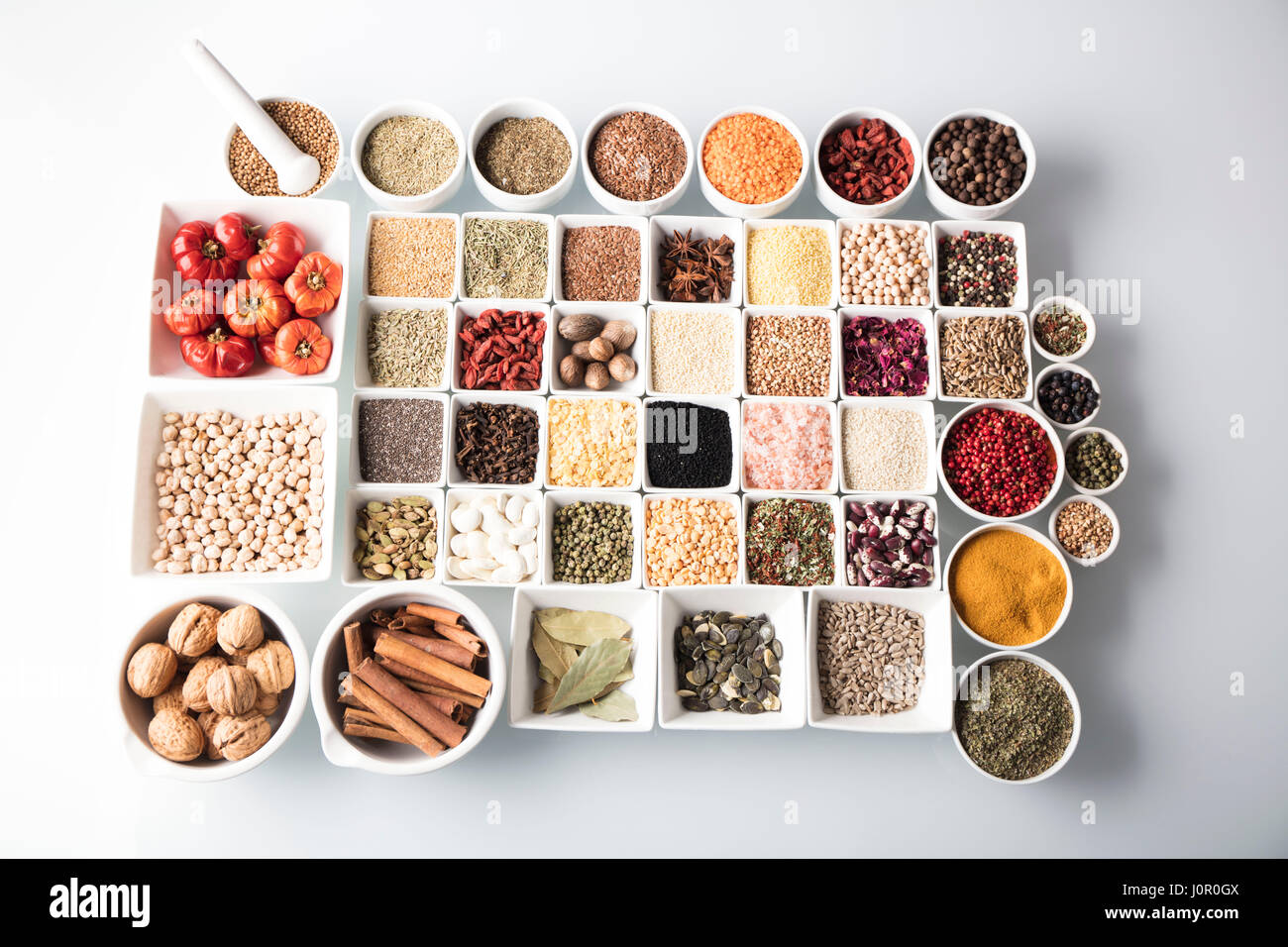 Spices and leguminous vegetables in bowls, isolated on white background ...