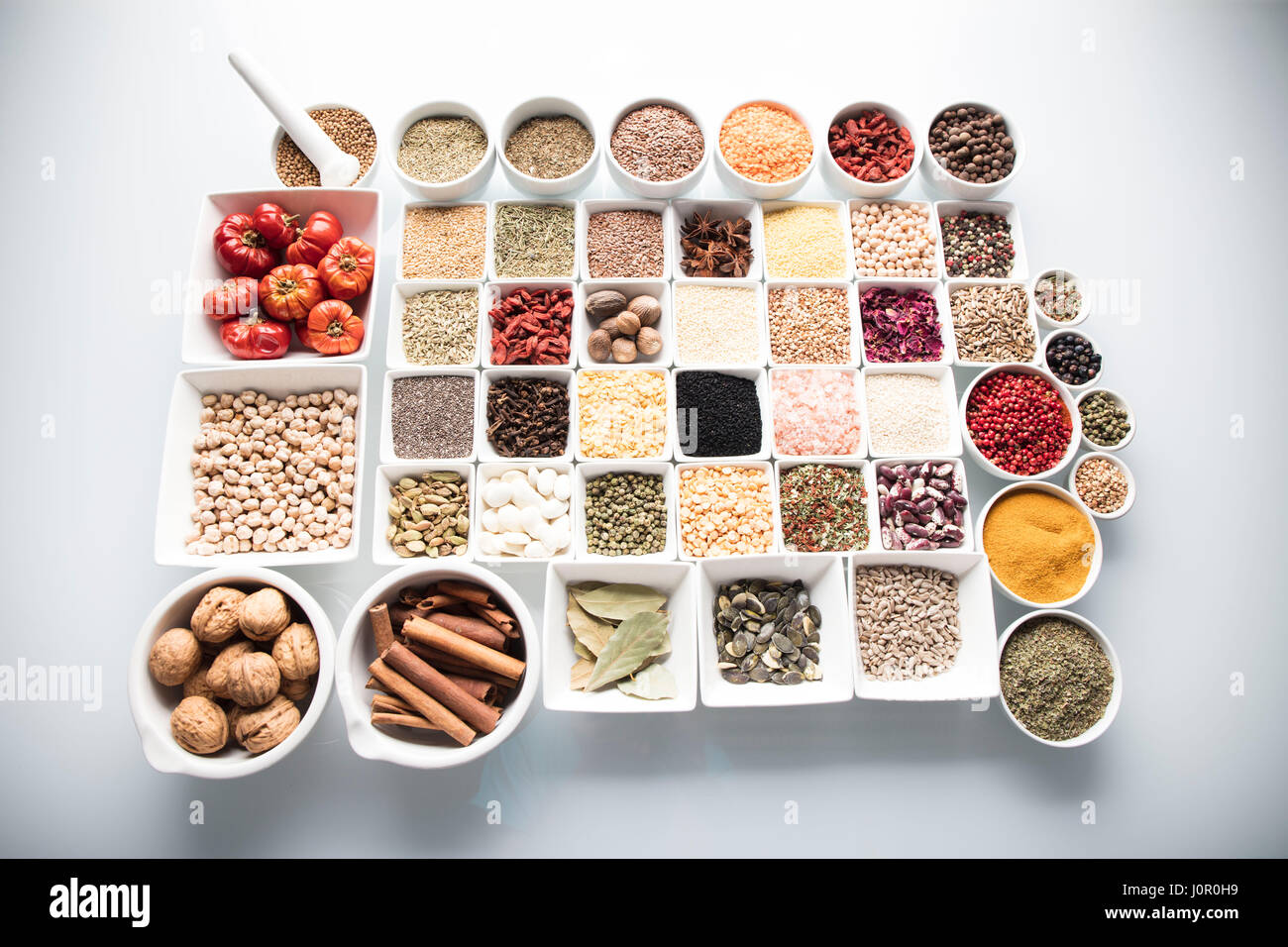Spices and leguminous vegetables in bowls, isolated on white background ...