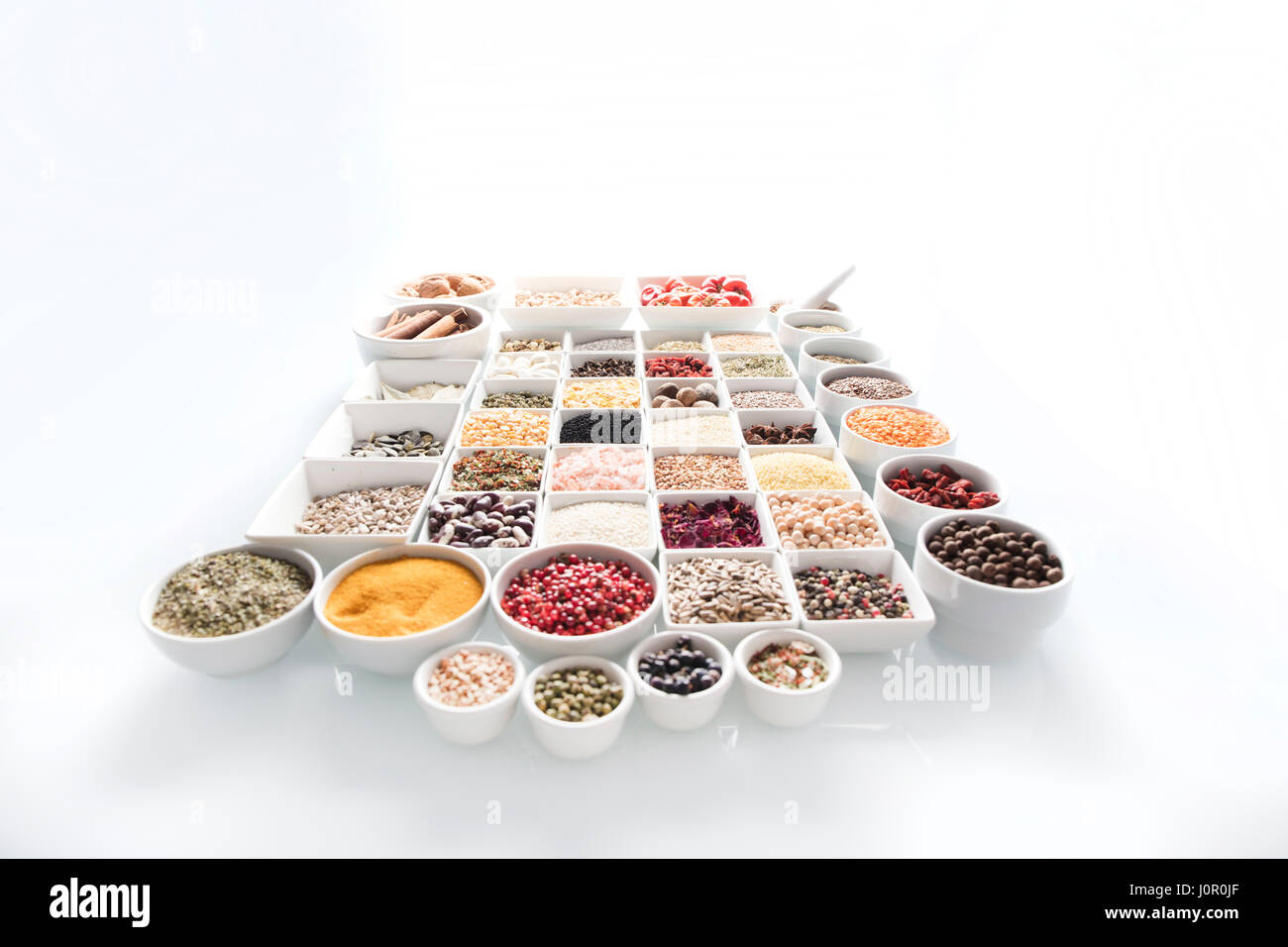 Spices and leguminous vegetables in bowls, isolated on white background ...