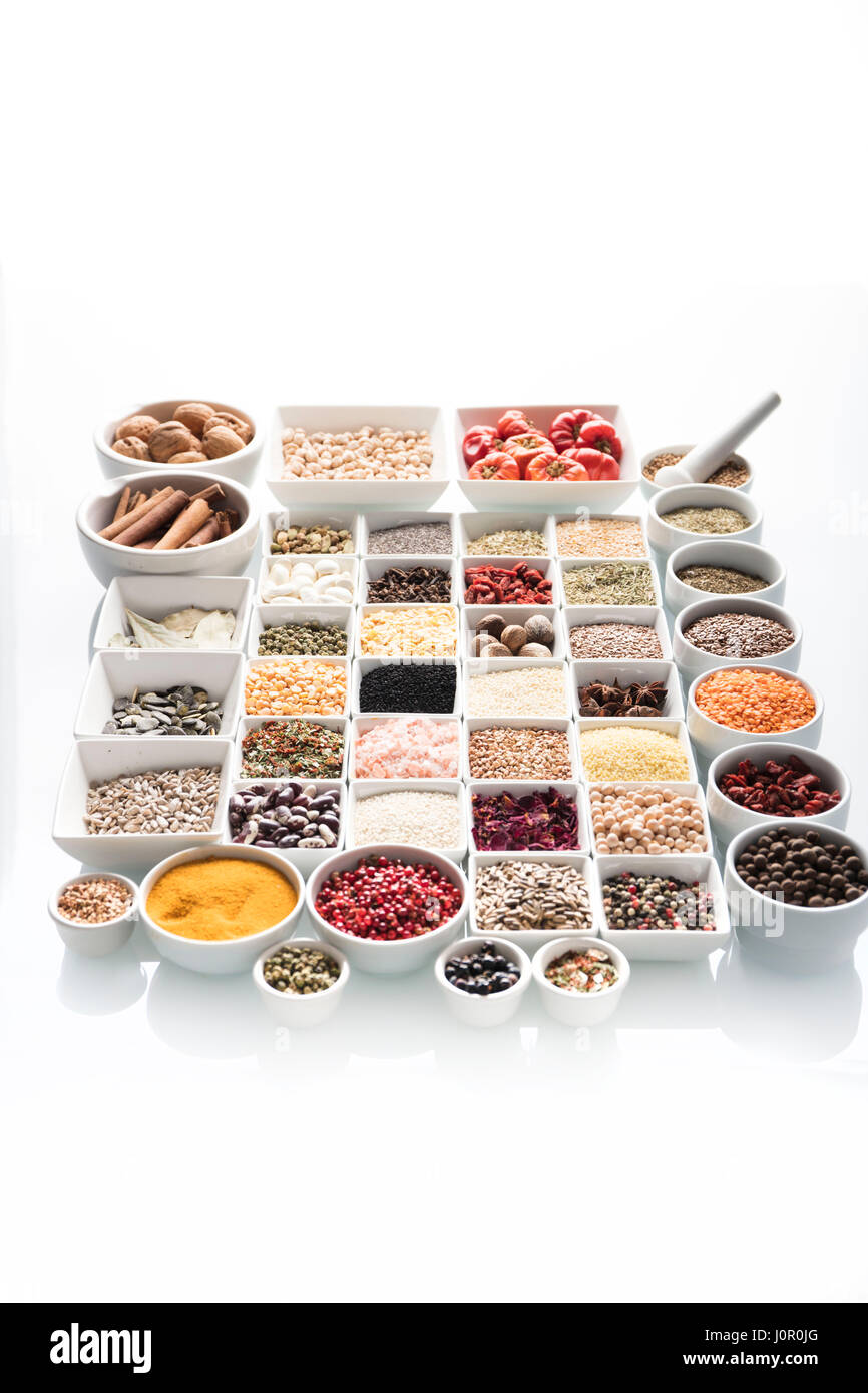 Spices and leguminous vegetables in bowls, isolated on white background ...