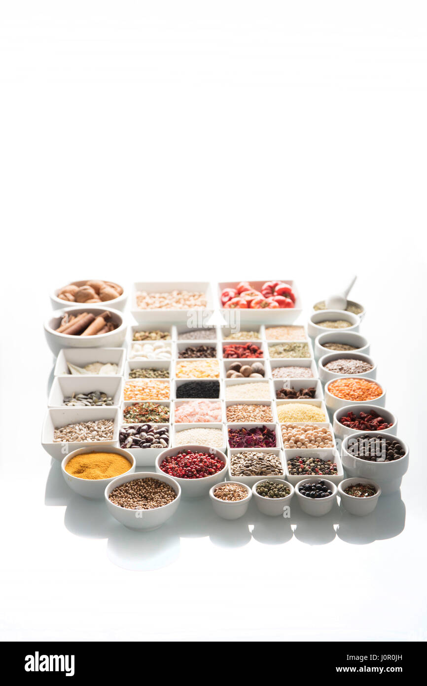 Spices and leguminous vegetables in bowls, isolated on white background ...