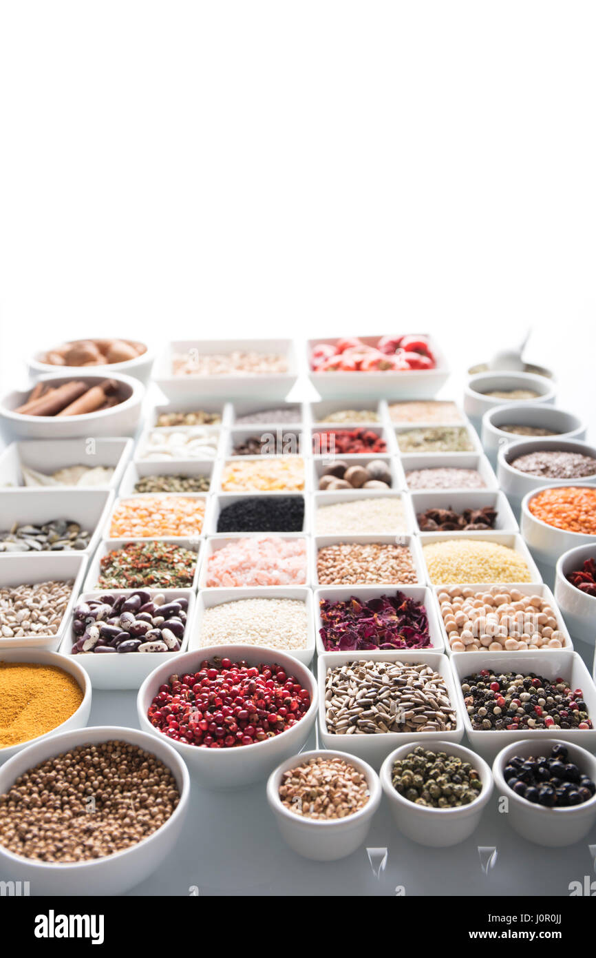 Spices and leguminous vegetables in bowls, isolated on white background ...