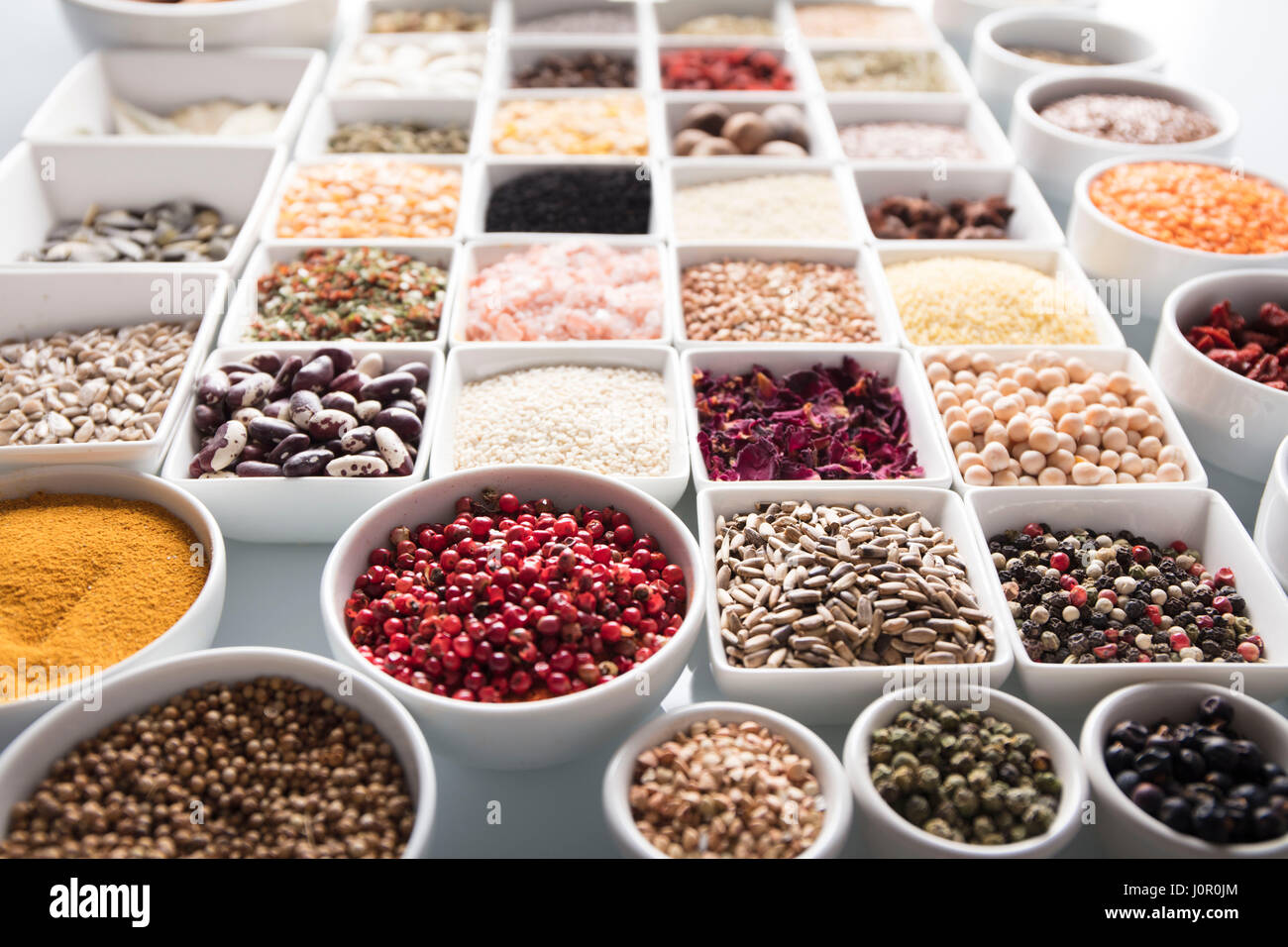 Spices and leguminous vegetables in bowls, isolated on white background ...