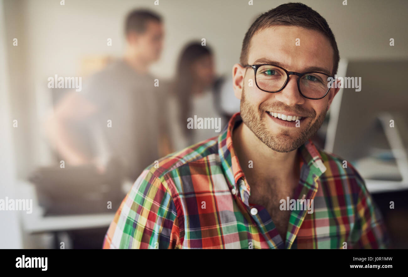 Horizontal portrait of a smiling office working man looking at camera ...