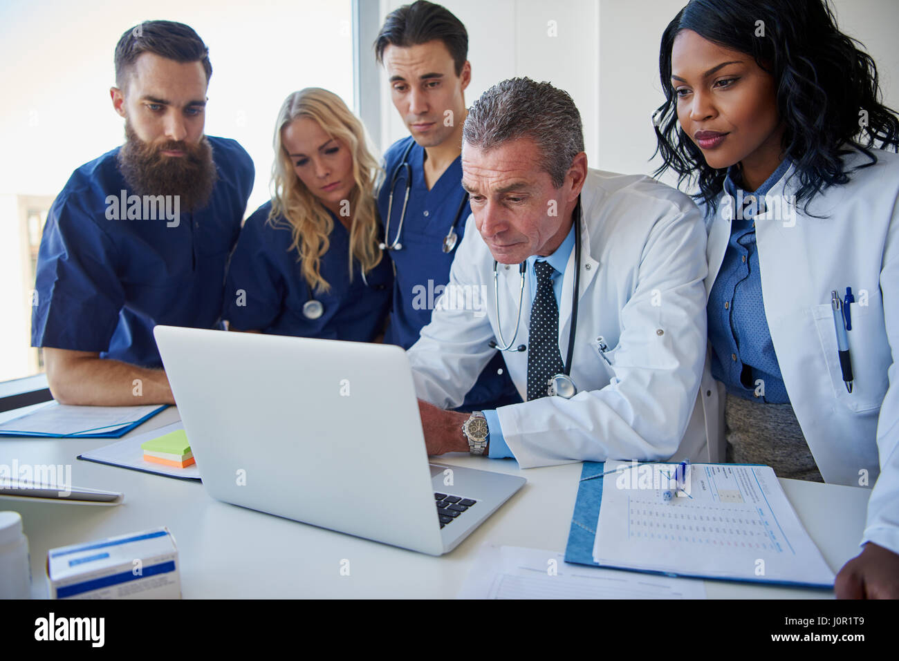 Clinical staff at a meeting. Looking at a computer together Stock Photo ...