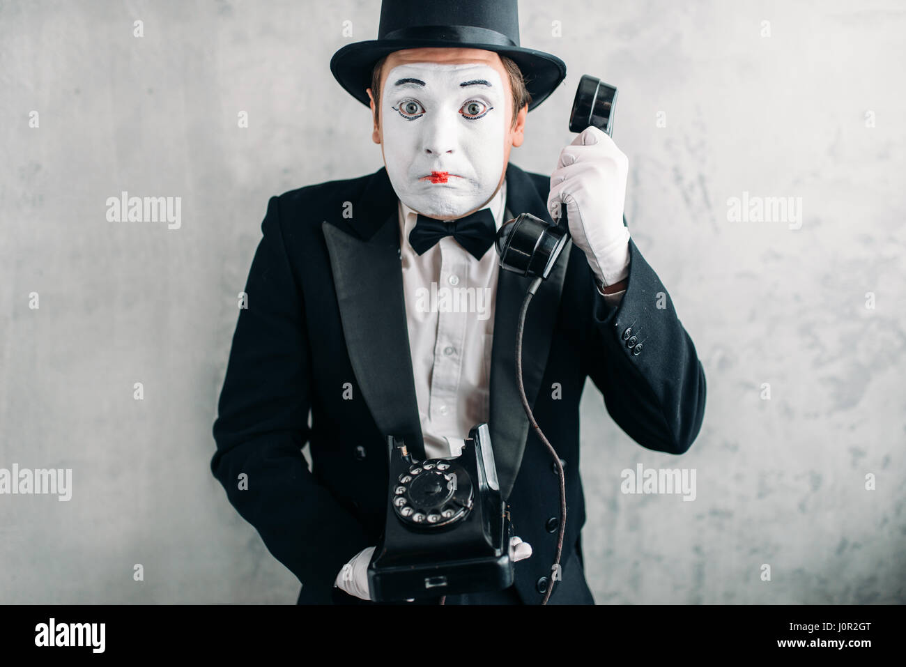 Pantomime theater actor with makeup mask performing with retro ...