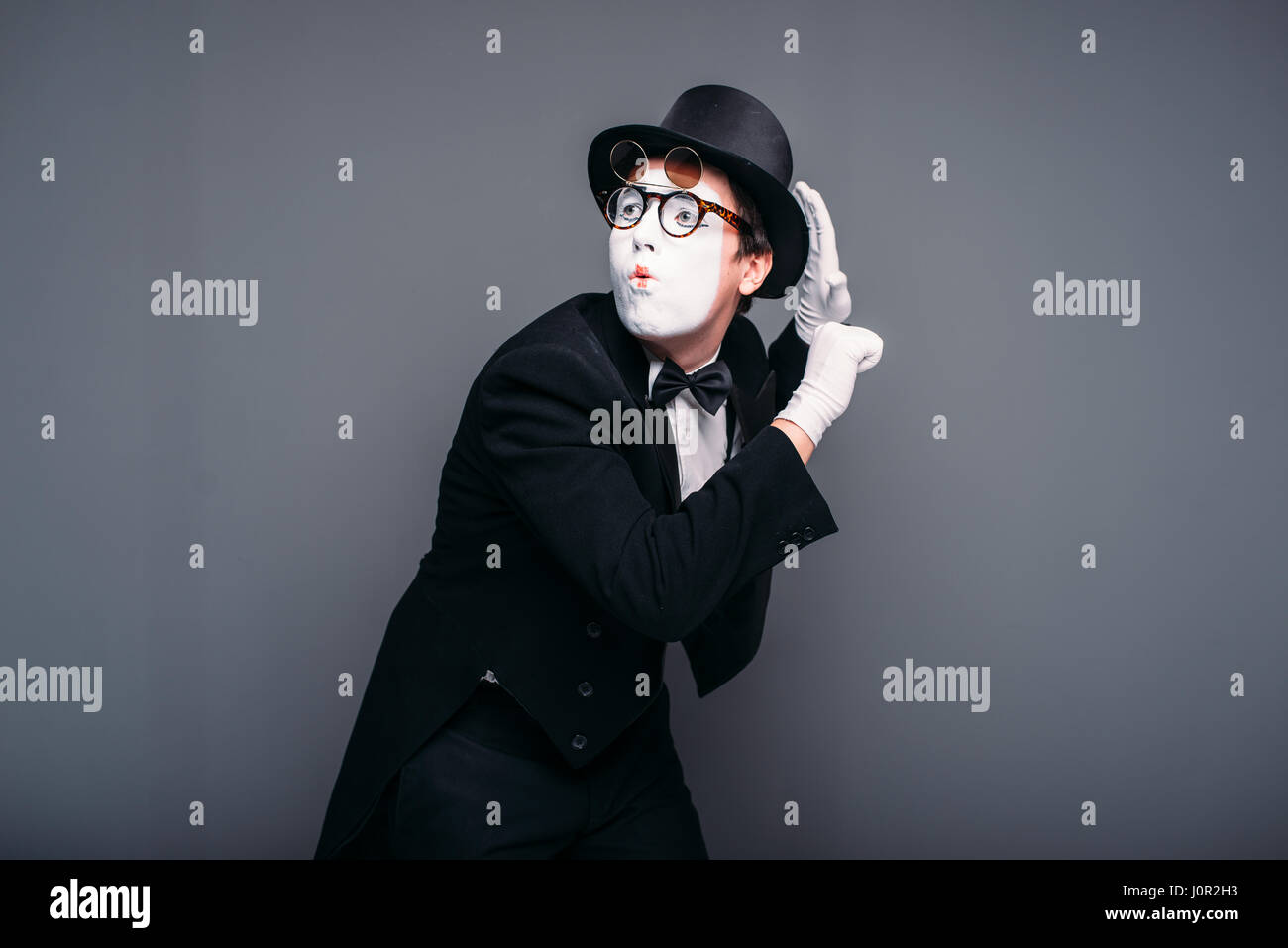 Male pantomime actor fun performing. Mime in suit, gloves, glasses ...