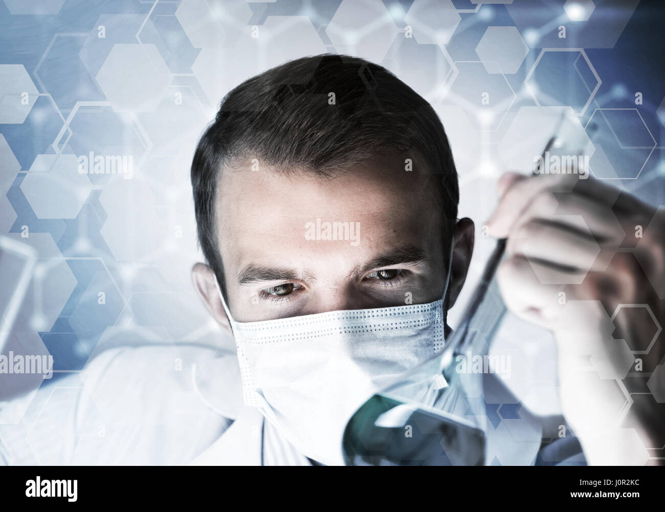 Portrait of concentrated male scientist working with reagents in ...