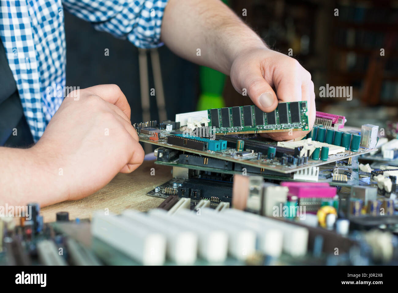 Service engineer work with broken computer motherboard. Electronic ...