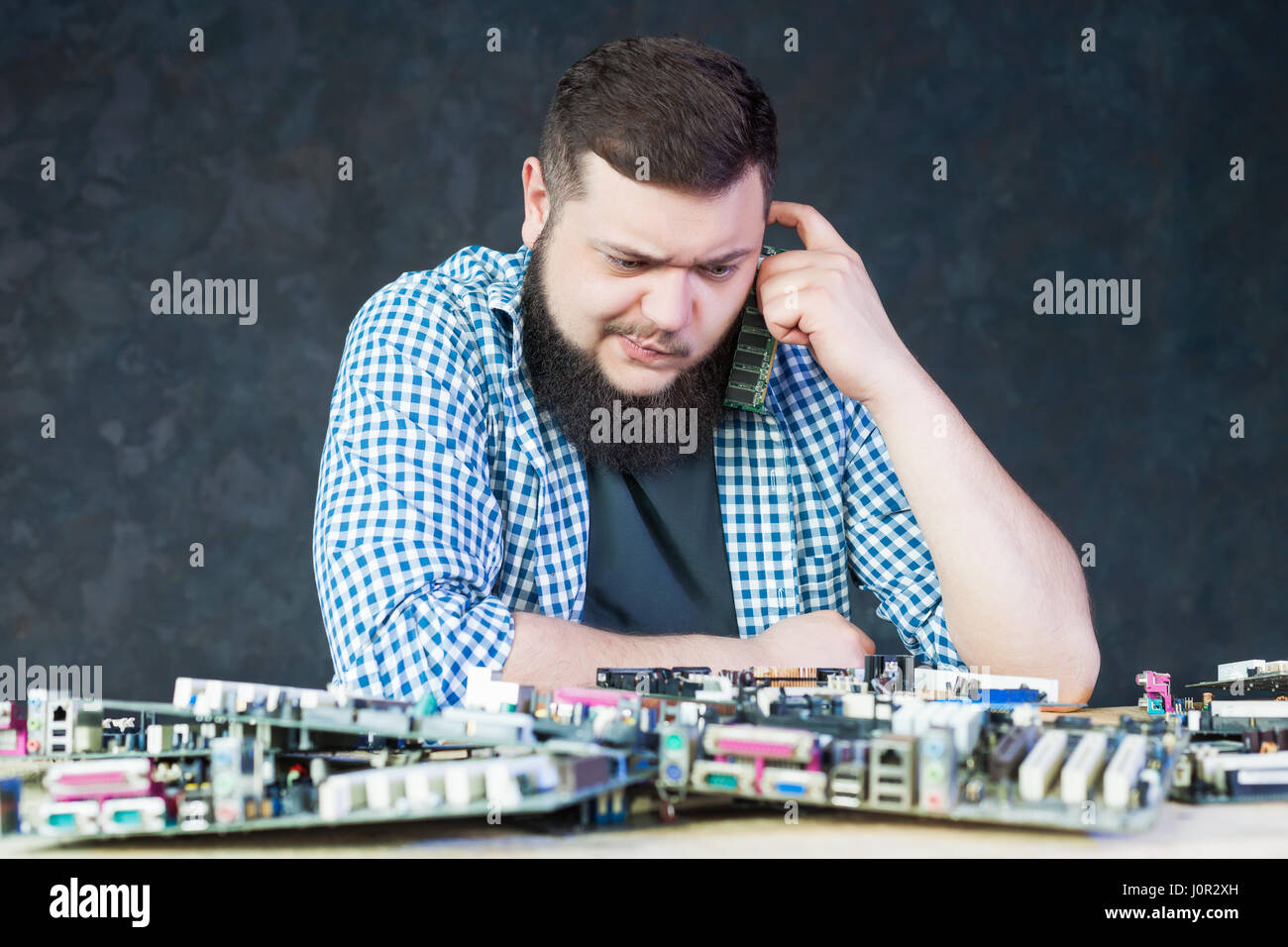 Male engineer work with broken computer motherboard. Electronic devices ...
