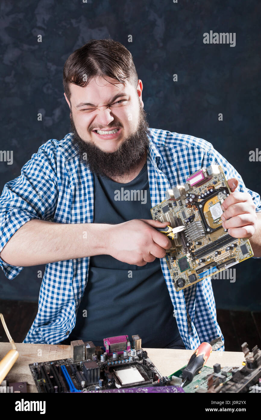 Service engineer repair pc motherboard. Repairman makes electronic ...