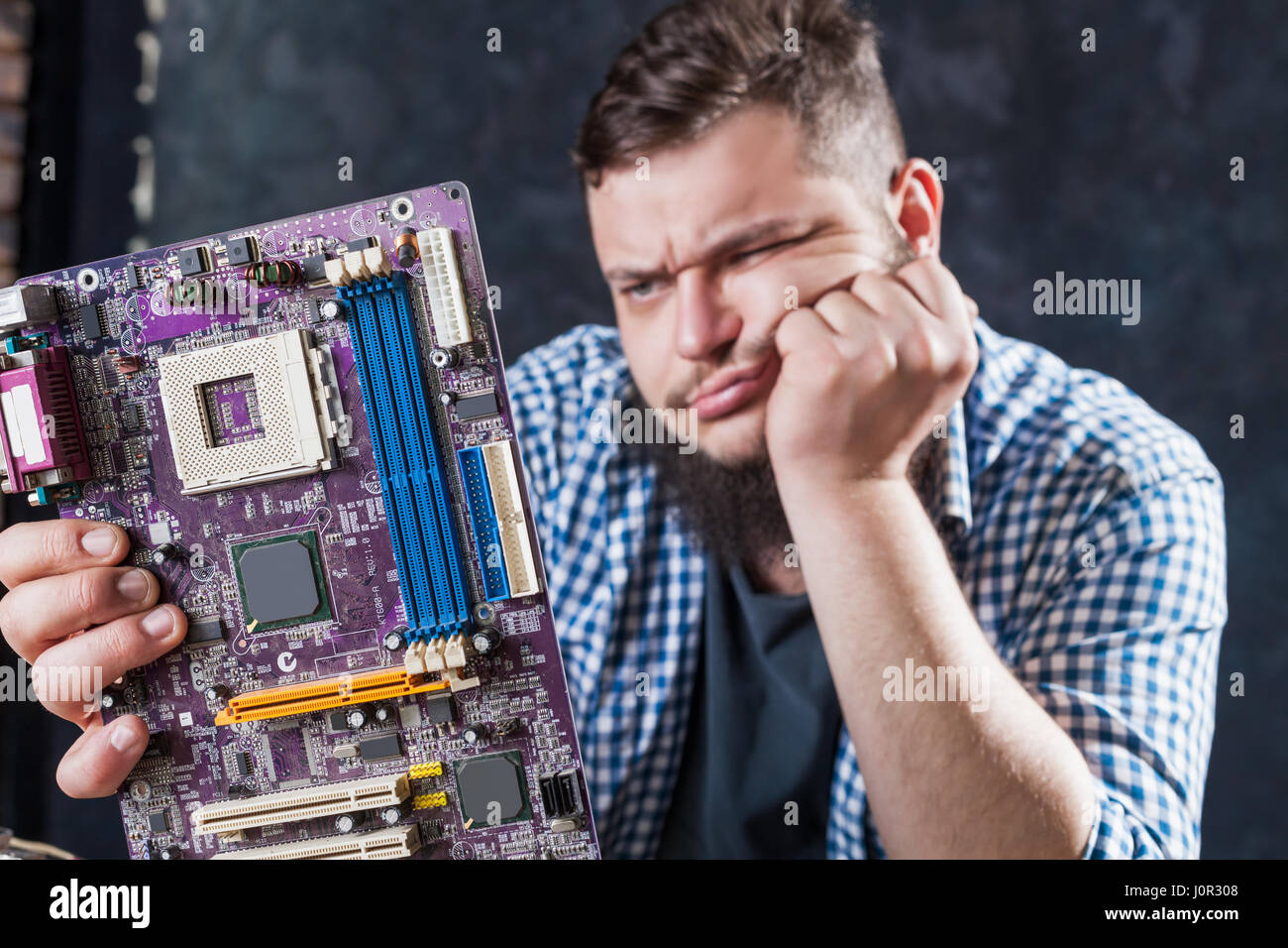 Service engineer fixing problem with computer motherboard. Repairman ...