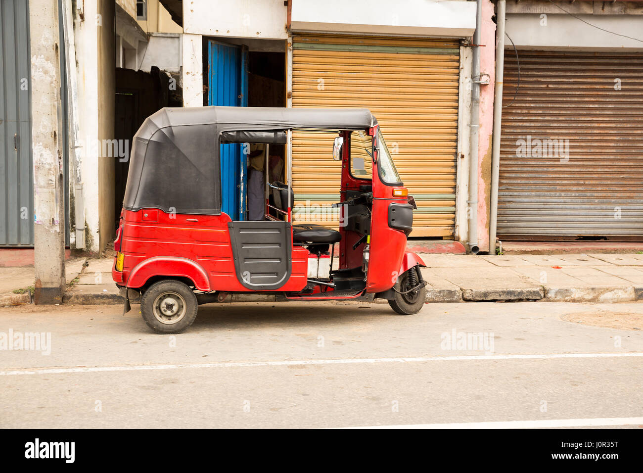 Tuk-tuk on road of Sri Lanka, side view. Ceylon traditional tourist ...