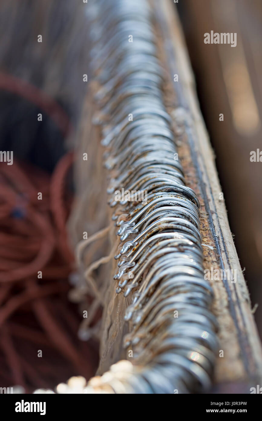 Fisherman placing hook in the box with fishing hooks Stock Photo - Alamy