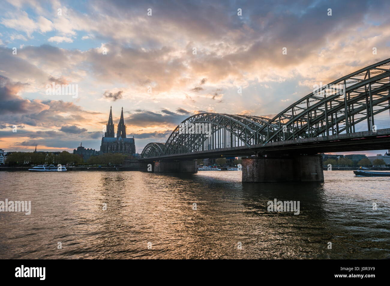Sunset view of Cologne Cathedral and Hohenzollern Bridge Stock Photo ...