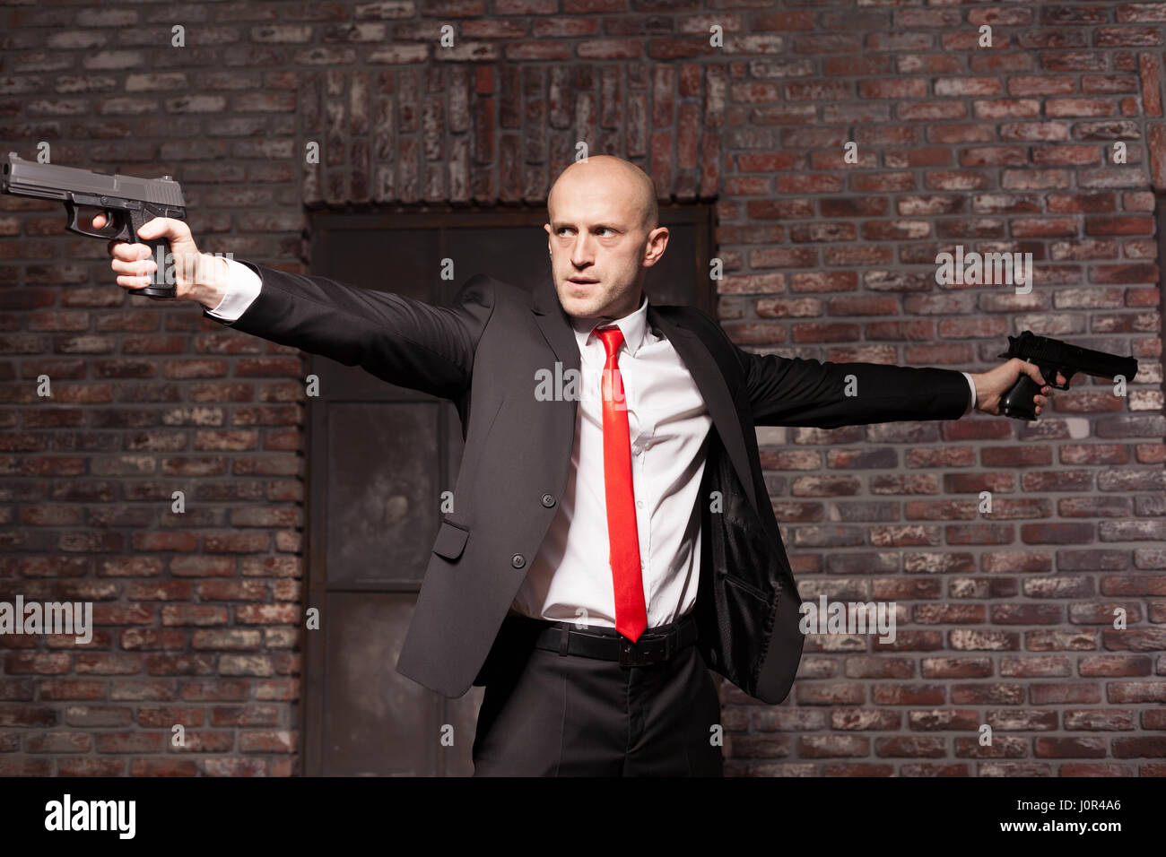 Serious contract killer shooting action wallpaper, background or poster ...
