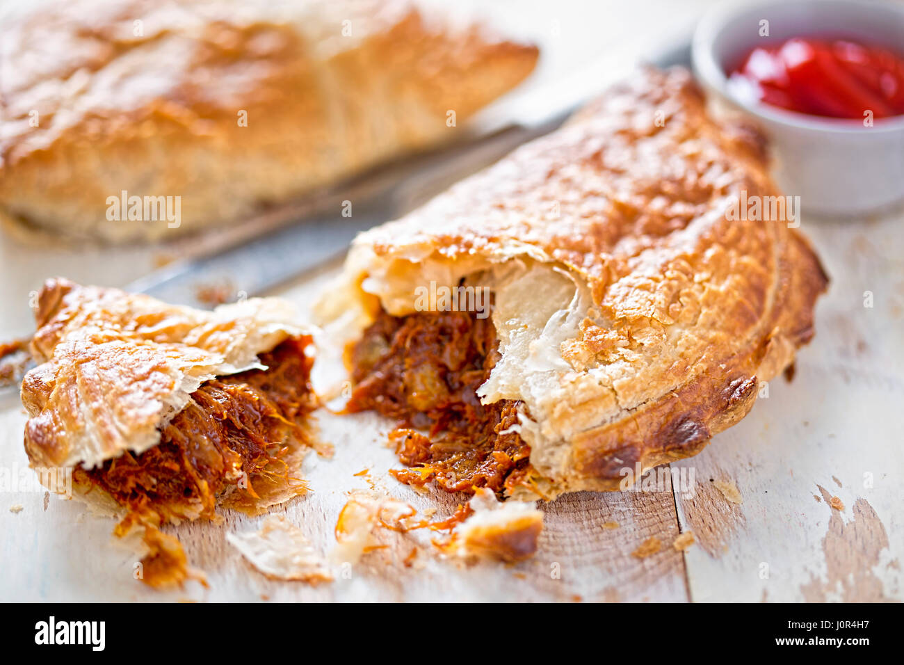 Pulled pork pastry in a barbecue flavoured sauce Stock Photo - Alamy