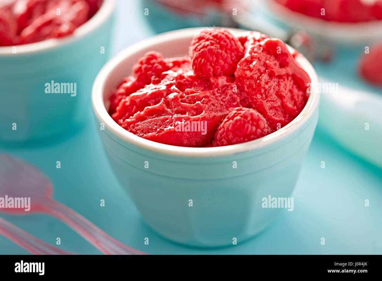 Raspberry sorbet in blue ramekins Stock Photo - Alamy