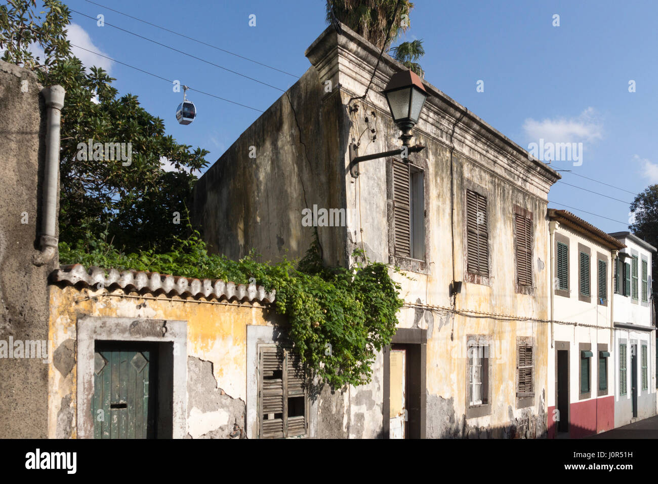Run down dilapidated buildings in a poor part of Funchal, Madeira. The ...