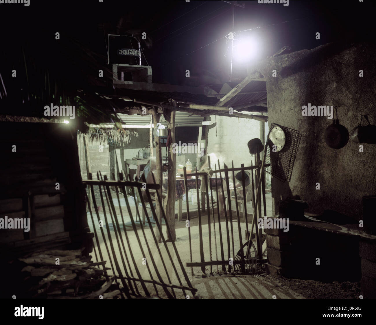 gate at night looking into courtyard Stock Photo - Alamy