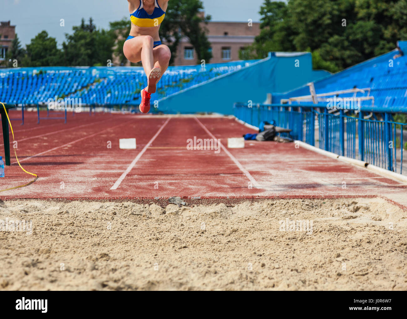 Sports competitions long jump, athlete in flight Stock Photo - Alamy