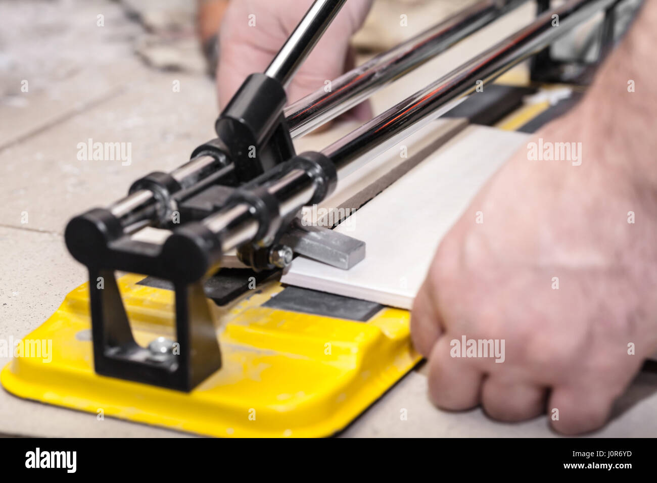 Repair work, men hands with tile cutters Stock Photo - Alamy