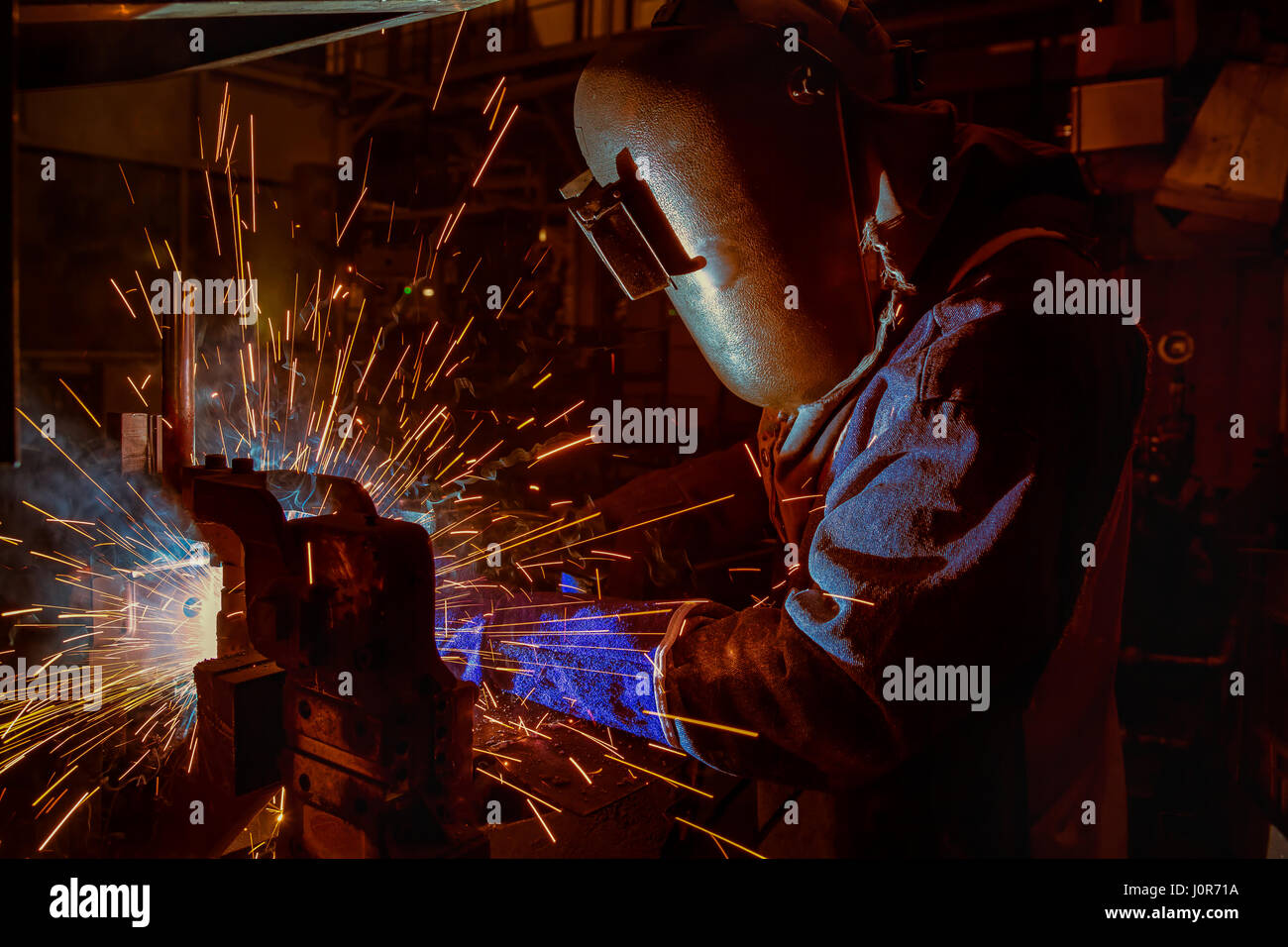 Workers are welding assembly steel part in factory Stock Photo - Alamy
