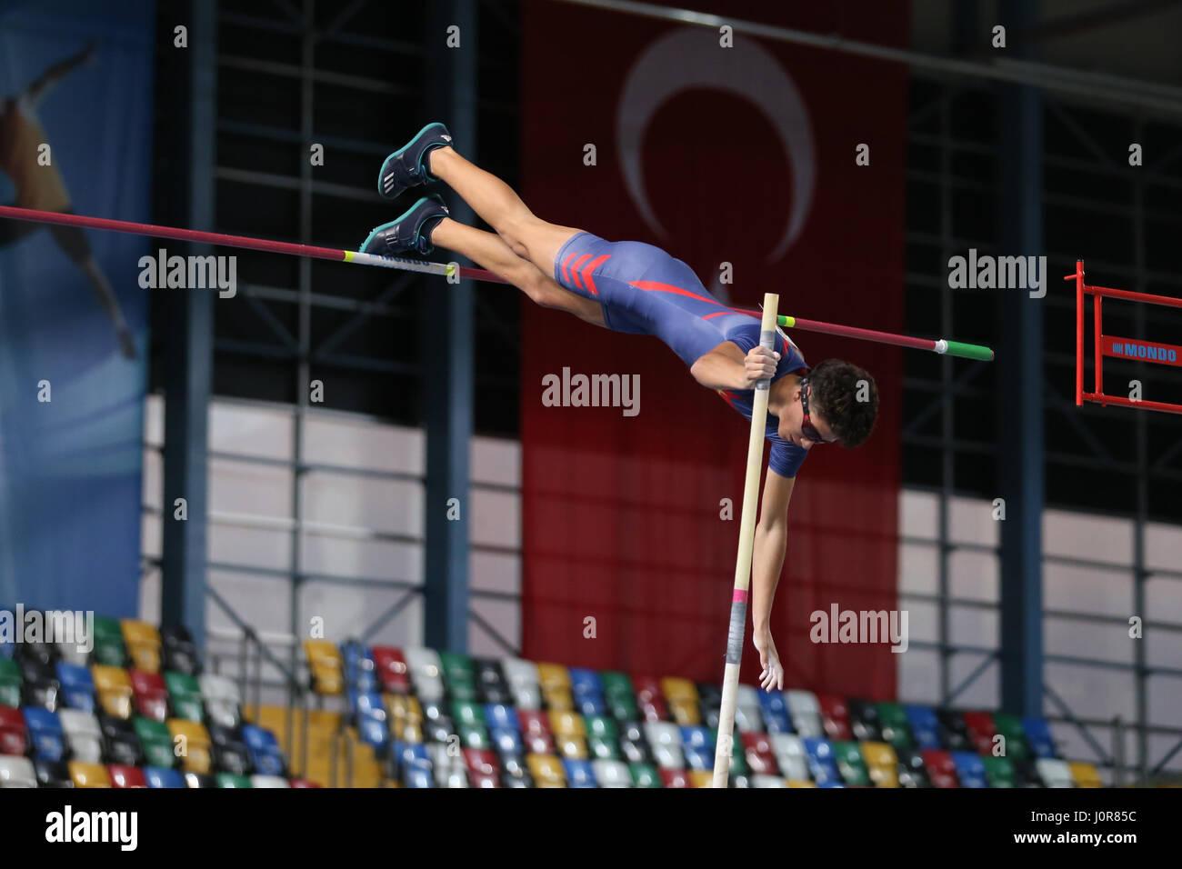 ISTANBUL, TURKEY - JANUARY 14, 2017: Athlete Ersu Sasma pole vaulting ...