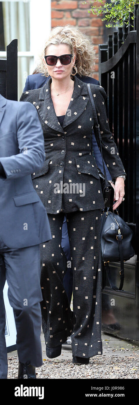 Kate Moss leaves her North London home with her driver carrying what ...