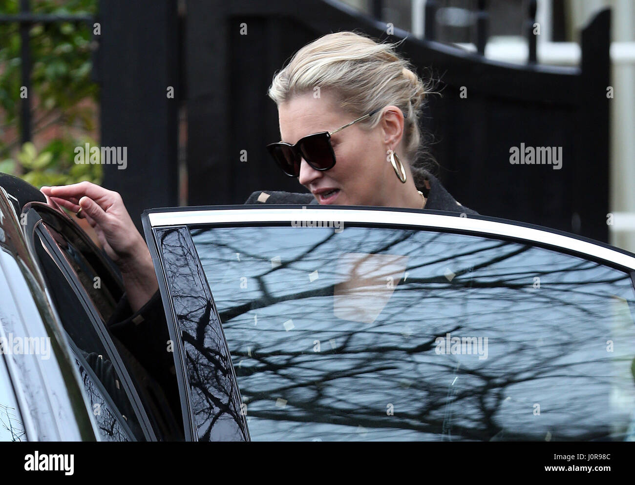 Kate Moss leaves her North London home with her driver carrying what ...
