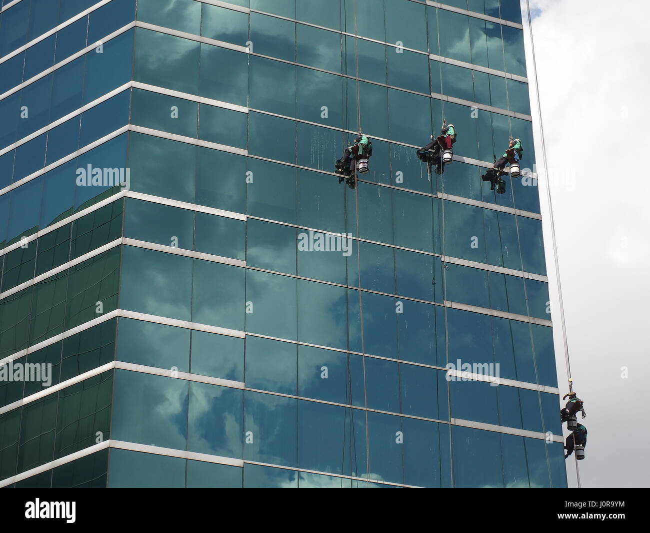Men cleaning glass building Stock Photo - Alamy