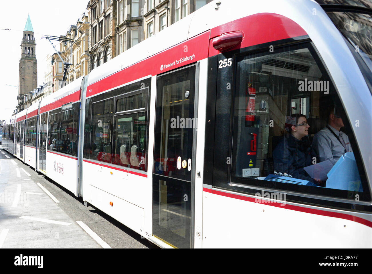 A tram makes its way through Edinburgh city centre in the final stages ...