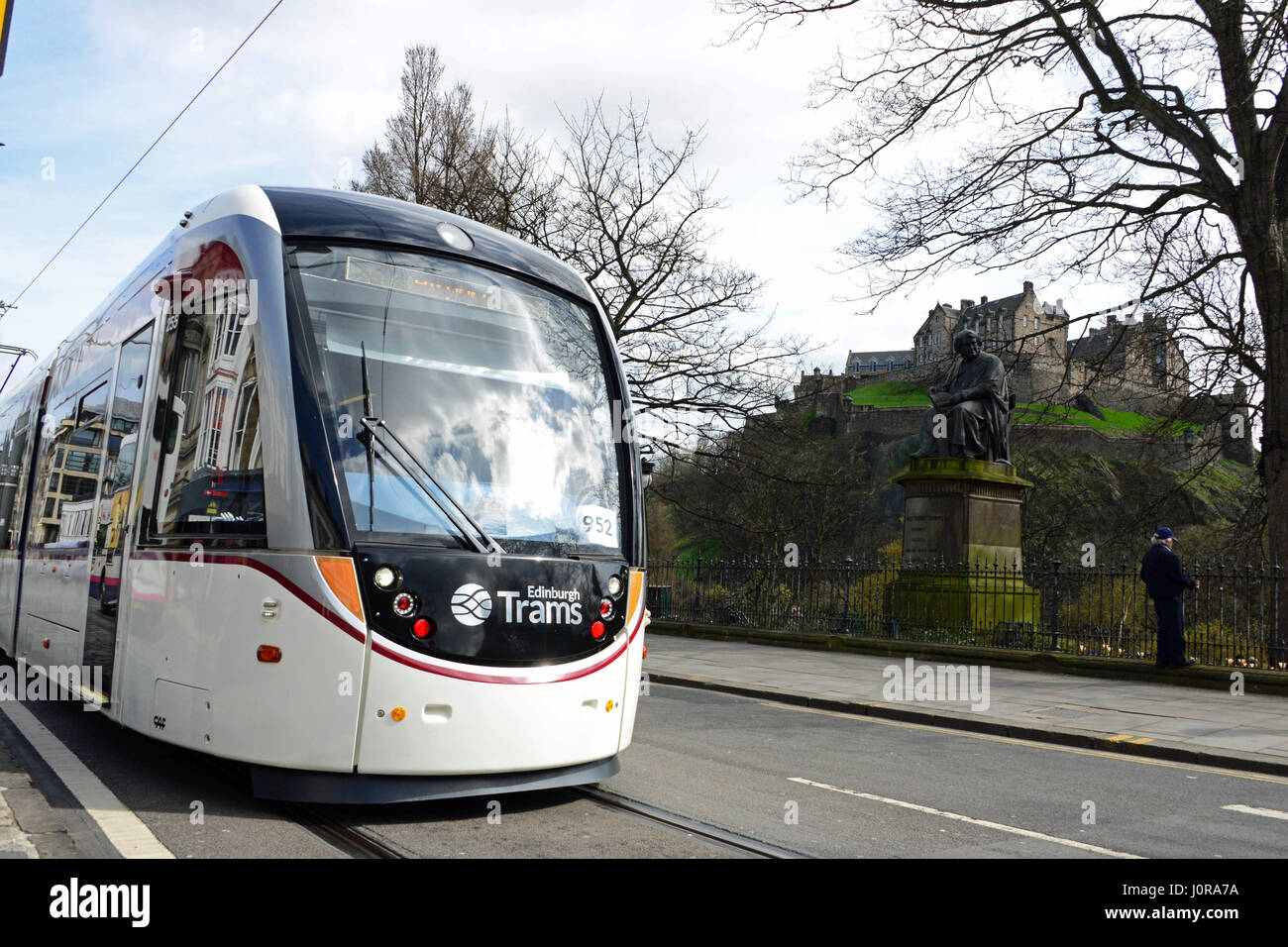 A tram makes its way through Edinburgh city centre with Edinburgh ...