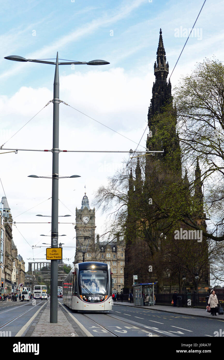 A tram makes its way through Edinburgh city centre with some of the ...