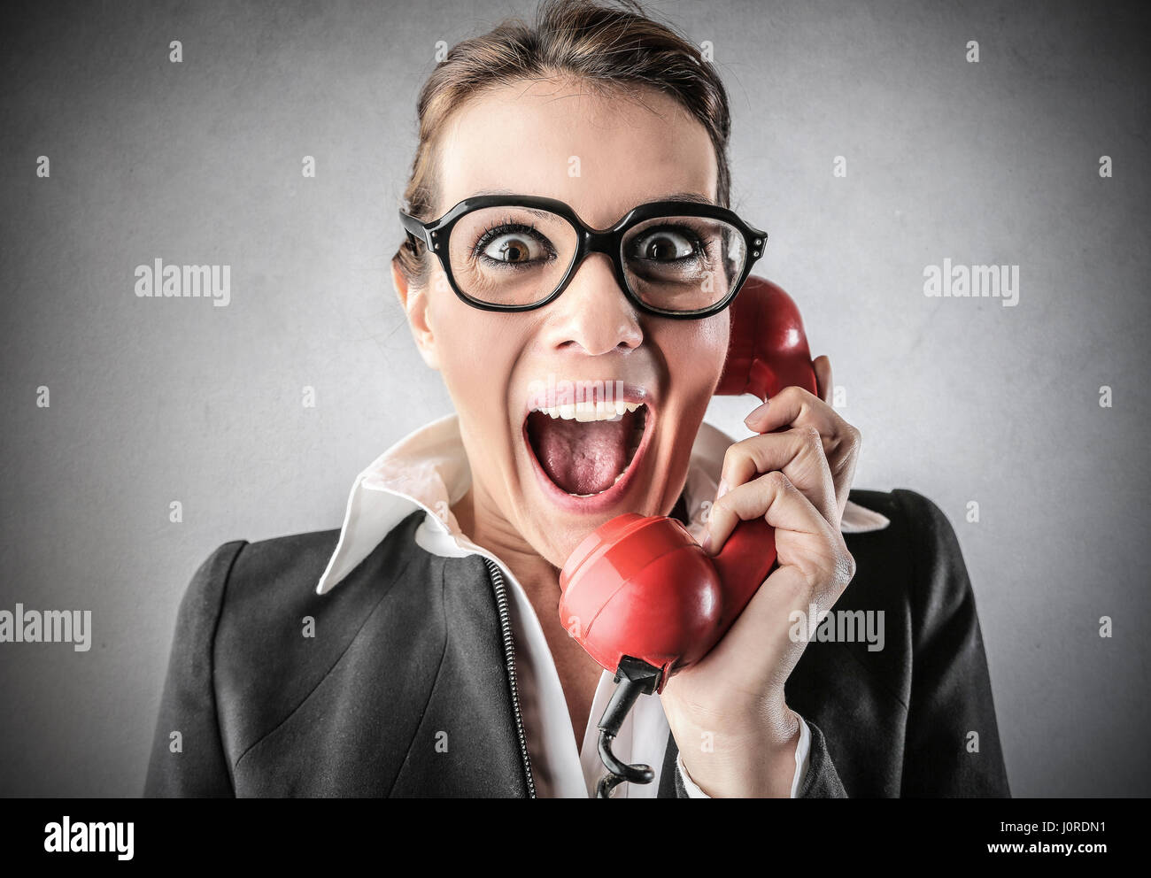 Excited businesswoman making a call Stock Photo - Alamy