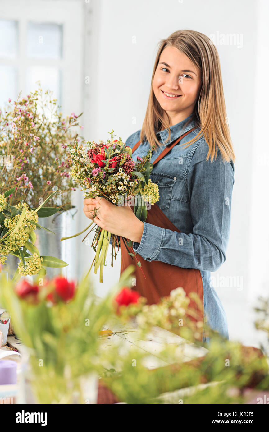 Florist at work: the young girl making fashion modern bouquet of ...