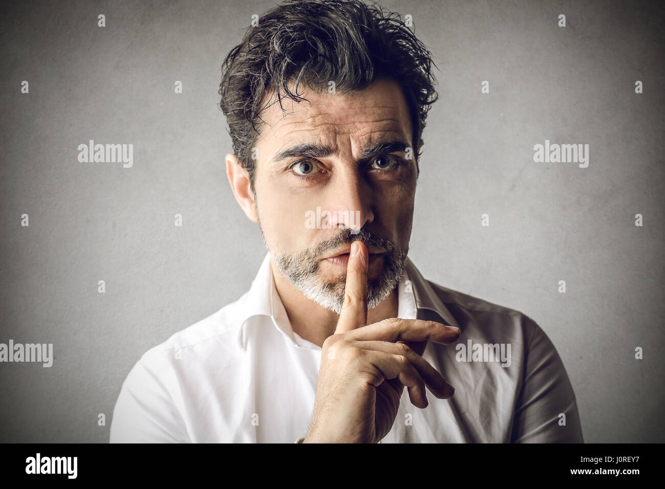 Man showing silence sign Stock Photo - Alamy