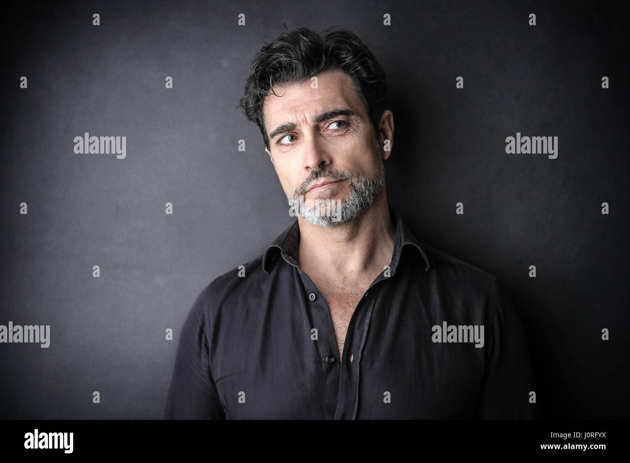 Man looking doubtful Stock Photo - Alamy