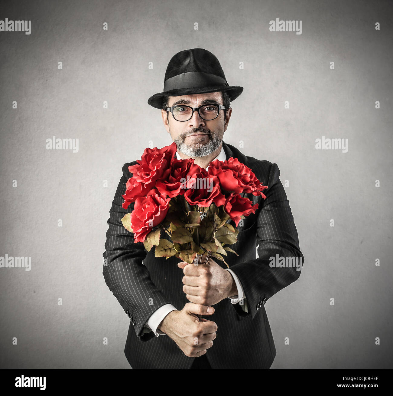 Elegant man with roses Stock Photo - Alamy