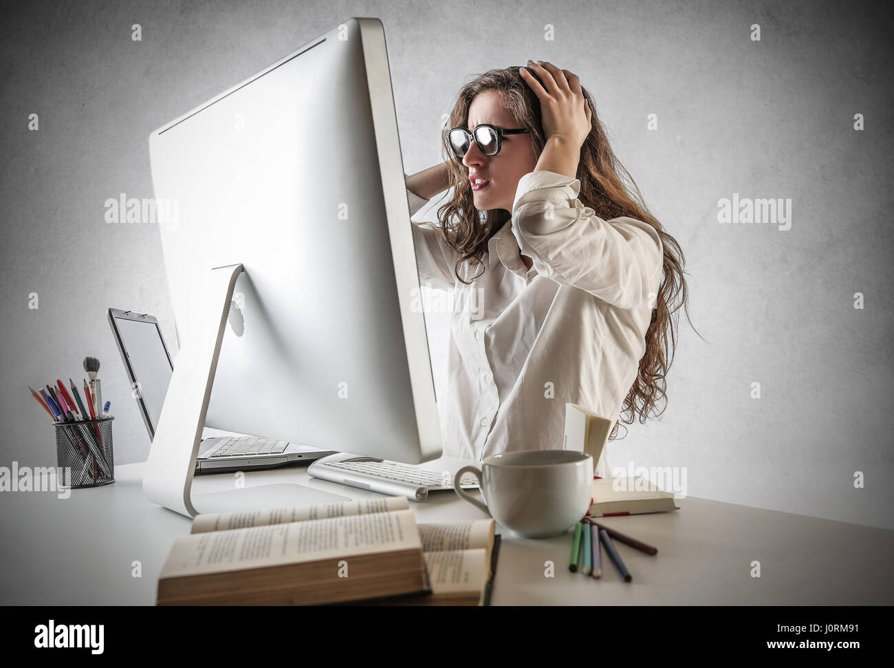 Blond woman being stressed in front of computer Stock Photo - Alamy