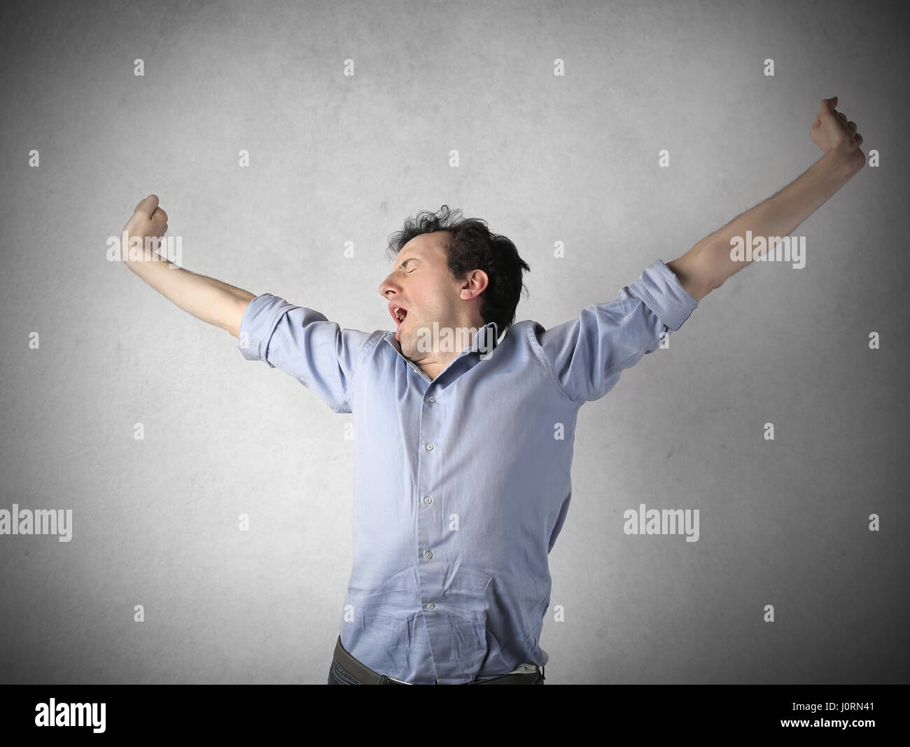 Tired man stretching Stock Photo - Alamy