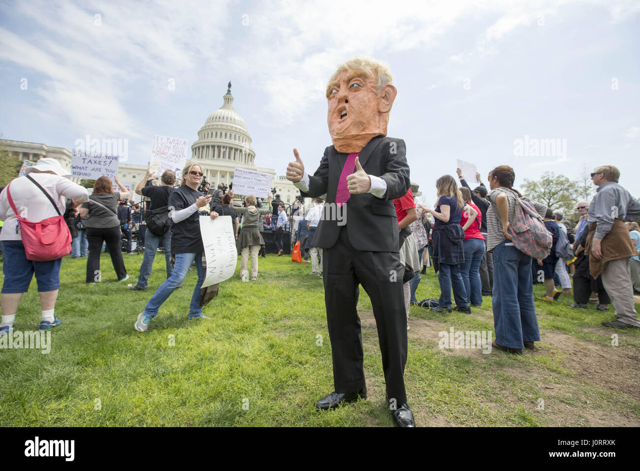 Washington, District of Columbia, USA. 15th Apr, 2017. A protestor with ...