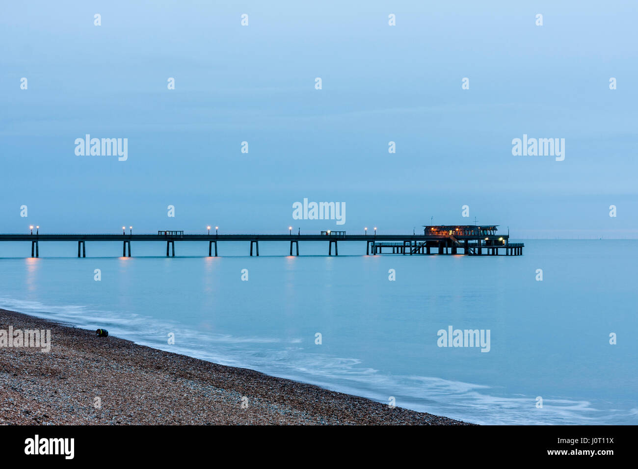 England, Deal pier. Twilight just before the dawn. Pier illuminated on ...