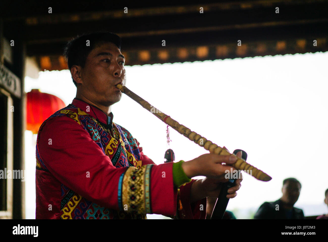 Chongqing. 15th Apr, 2017. A performer plays a local musical instrument ...
