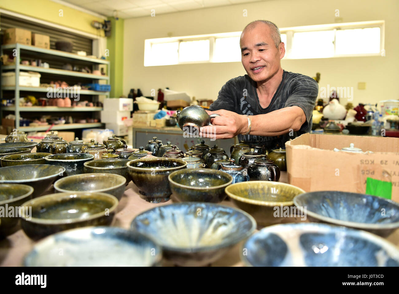 Taipei. 16th Apr, 2017. Ceramist Chen Chin Wang sorts out ceramics at ...