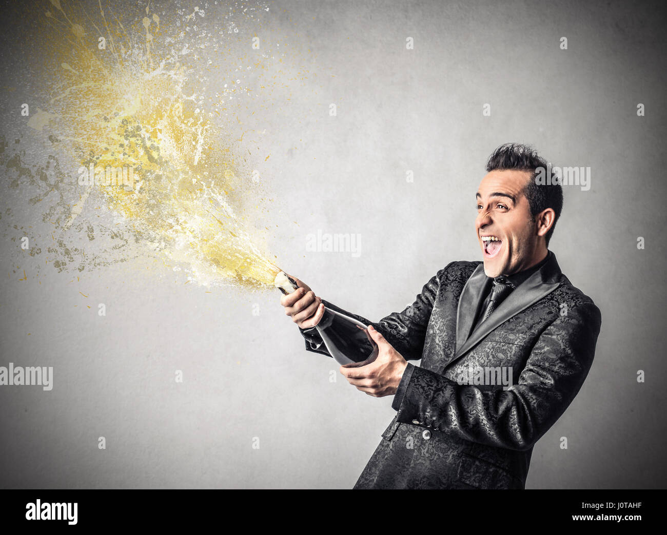 Elegant man opening a bottle of champagne Stock Photo - Alamy
