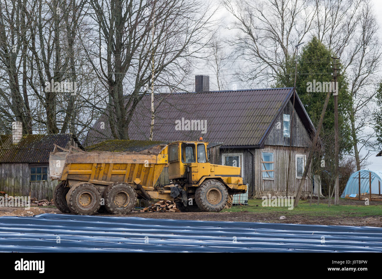 The big dump truck stay at the building Stock Photo - Alamy